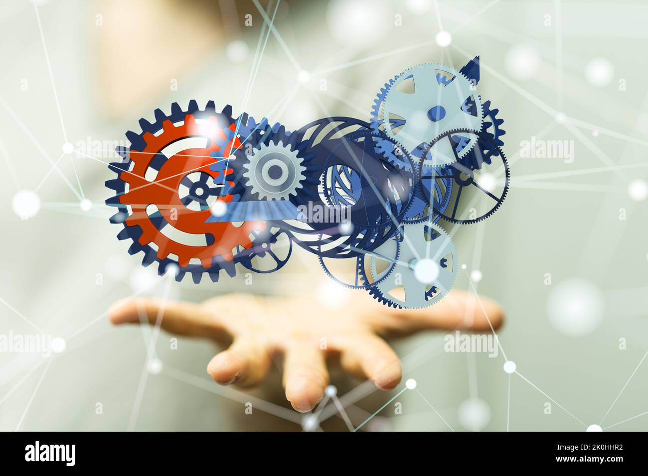 A businessman presenting a 3D rendered hologram of a gear system in a ...