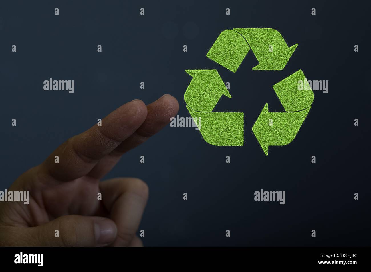 The hands holding the recycle sign before the black background Stock ...