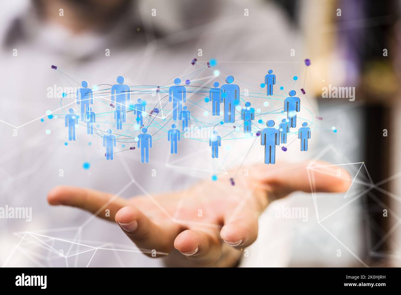 Blue icons of people linked together floating above a hand Stock Photo ...