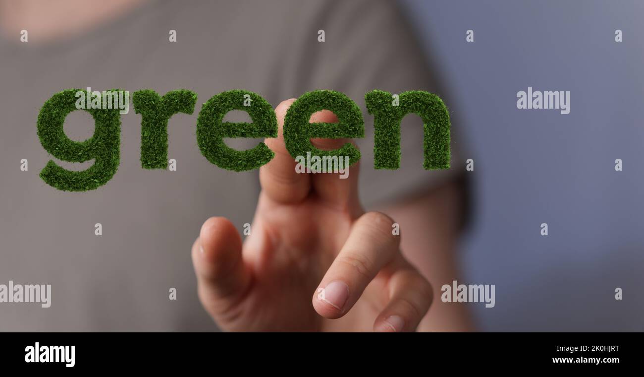 A person's hand pointing at the hovering word green with grass texture ...
