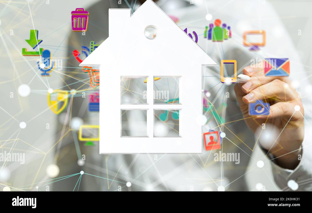 A person showing a house icon with connections on a blurred background ...