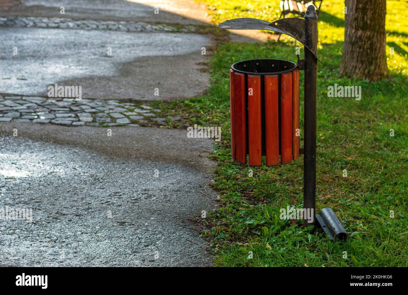 A trash can in a park near a footpath Stock Photo - Alamy