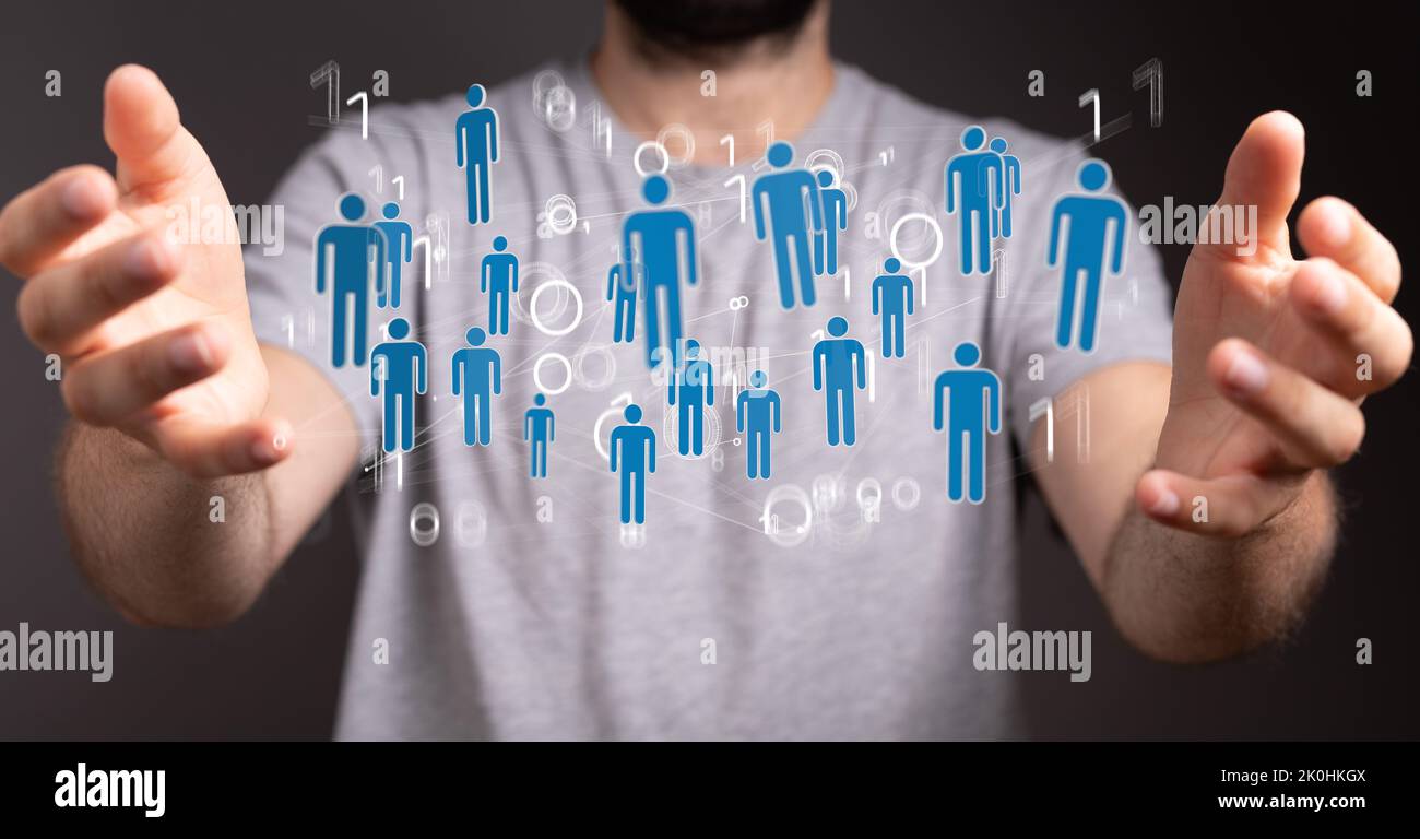 A man with his hands out toward floating 3D people icons - concept of ...