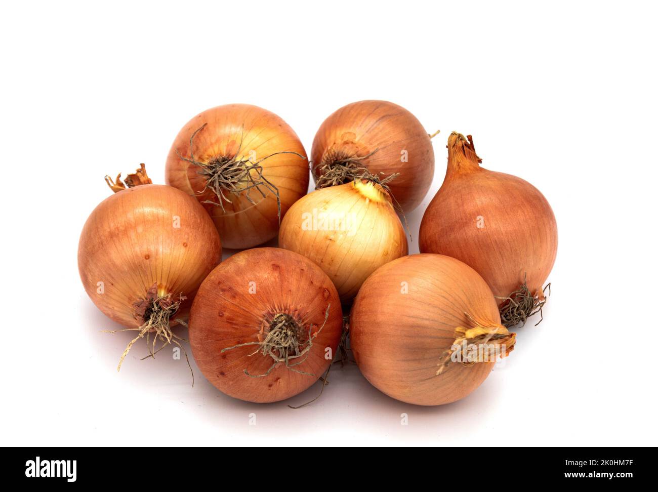 A handful of fresh yellow onions isolated on a white background Stock ...
