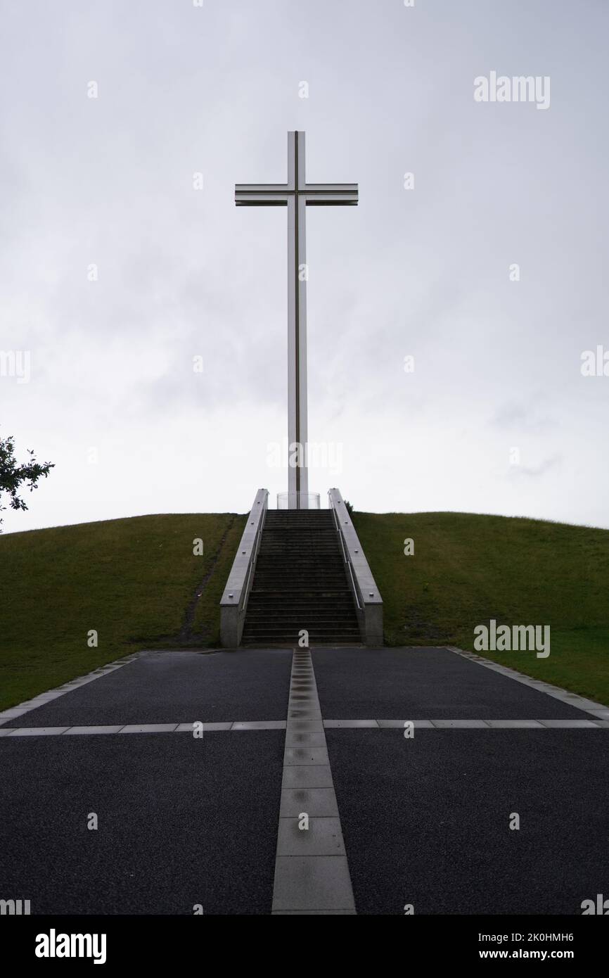 A tall cross with a cloudy sky background Stock Photo - Alamy