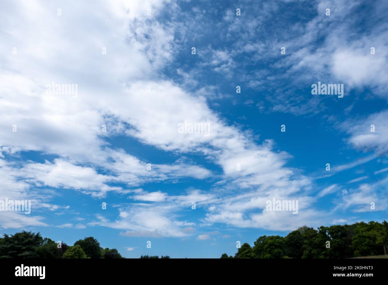 A tranquil blue sky background with clouds Stock Photo - Alamy