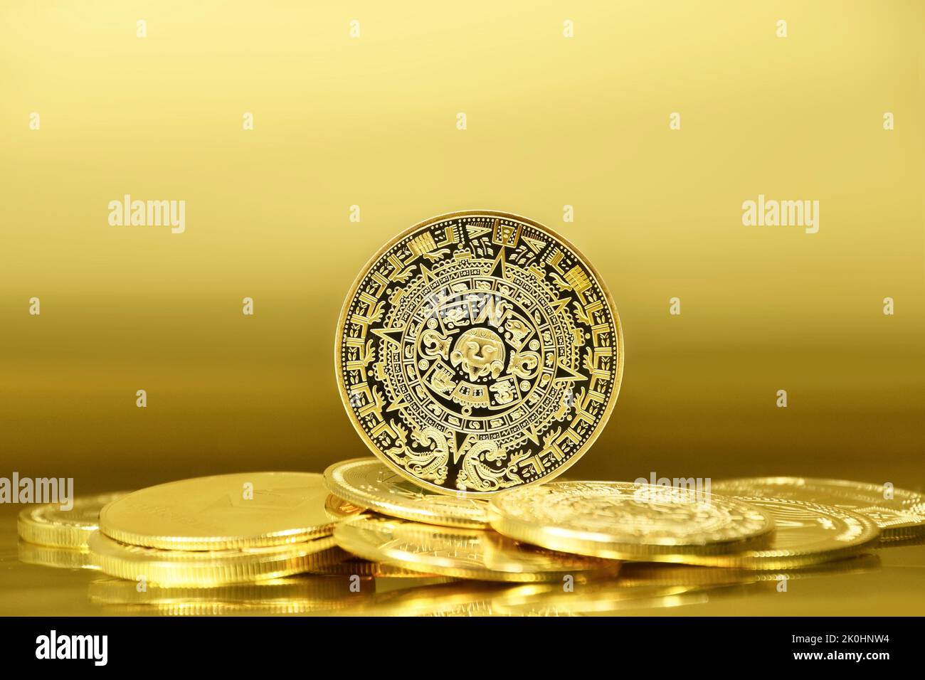 A closeup shot of Maya cryptocurrency coins on a golden background ...