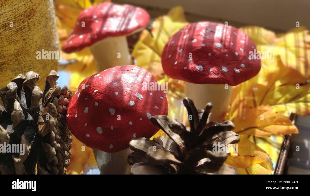 Cute autumn decorations like mushrooms, pine cones near a window Stock ...