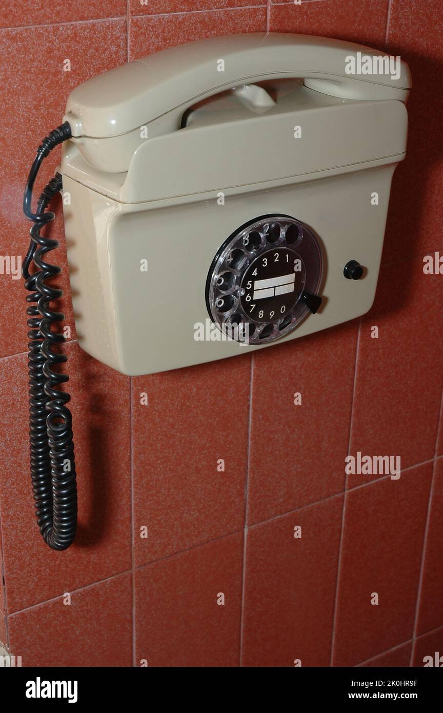 a vertical shot of a classic telephone set hanging on the wall Stock ...