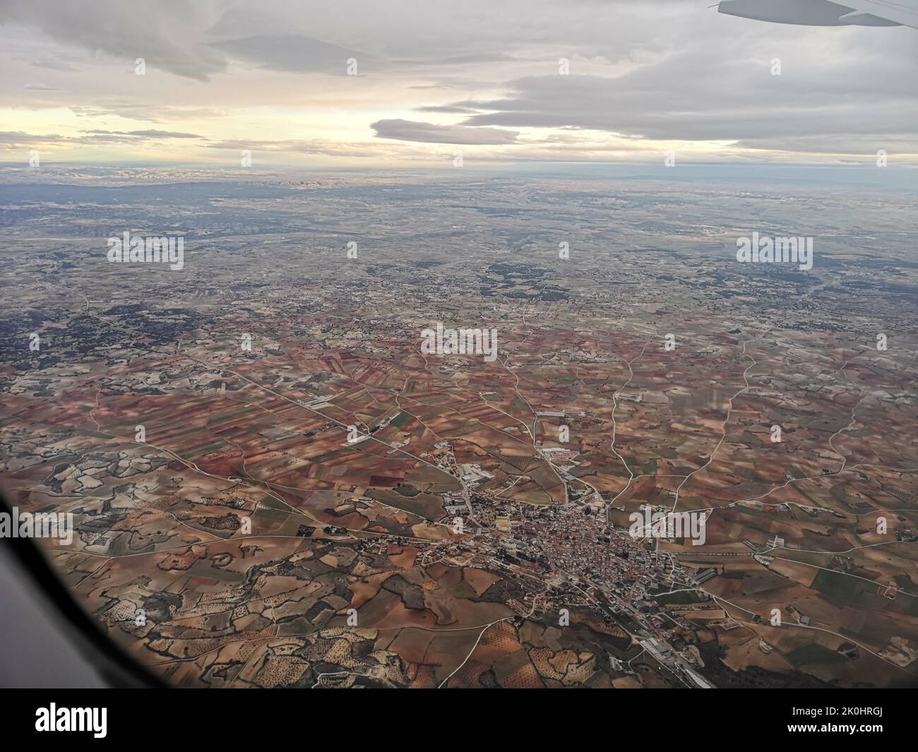 A bird's eye view of the cityscape of Madrid, Spain under a cloudy sky ...