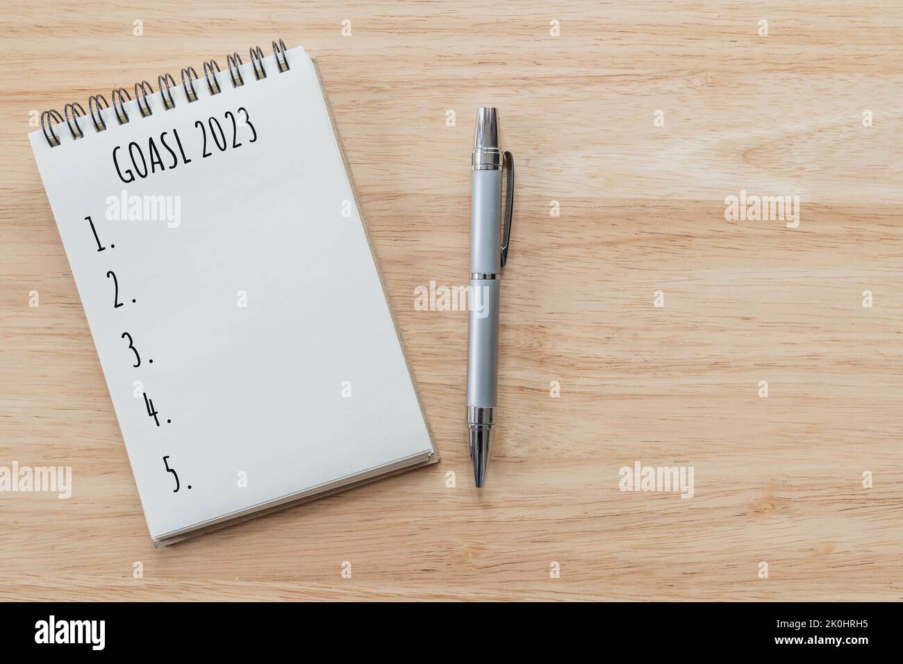 Top view of notepad with Goals 2023 List on wooden table, goals concept ...