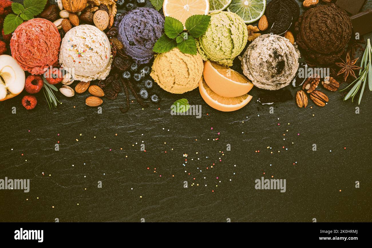 A top view of colorful ice cream balls with different fruit and nut ...