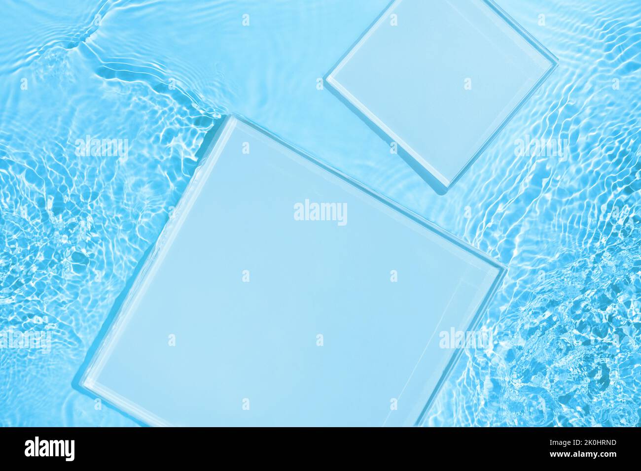 Two empty square podiums on transparent blue water background Stock ...