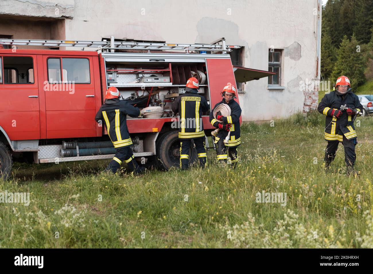 Group of fire fighters standing confident after a well done rescue ...