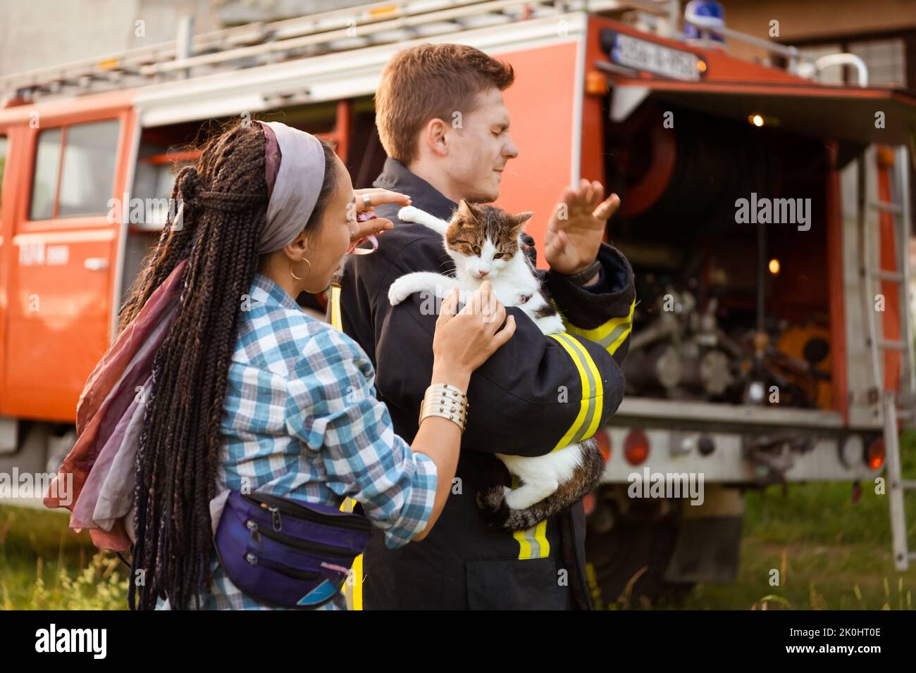 Close-up portrait of heroic fireman in protective suit and red helmet ...