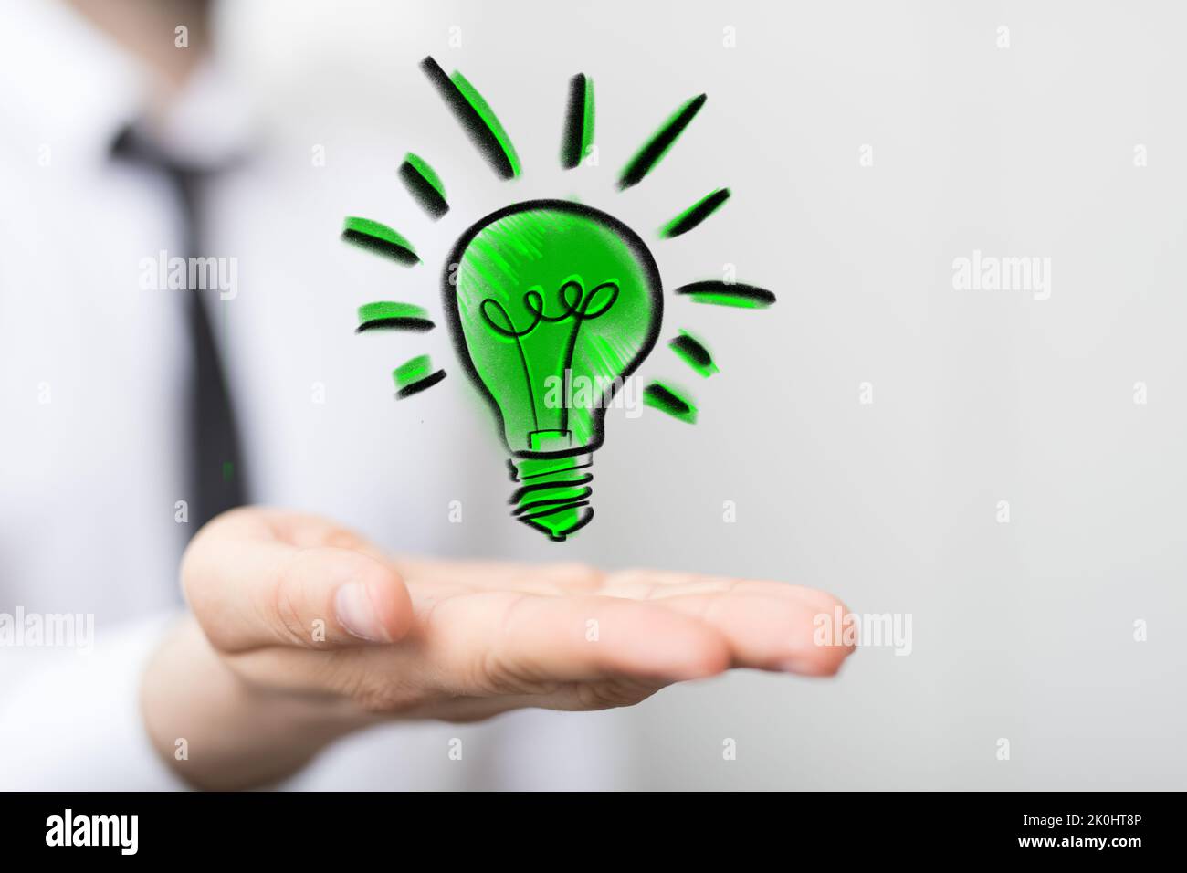 A man presenting the illustrated light bulb over his hand Stock Photo ...