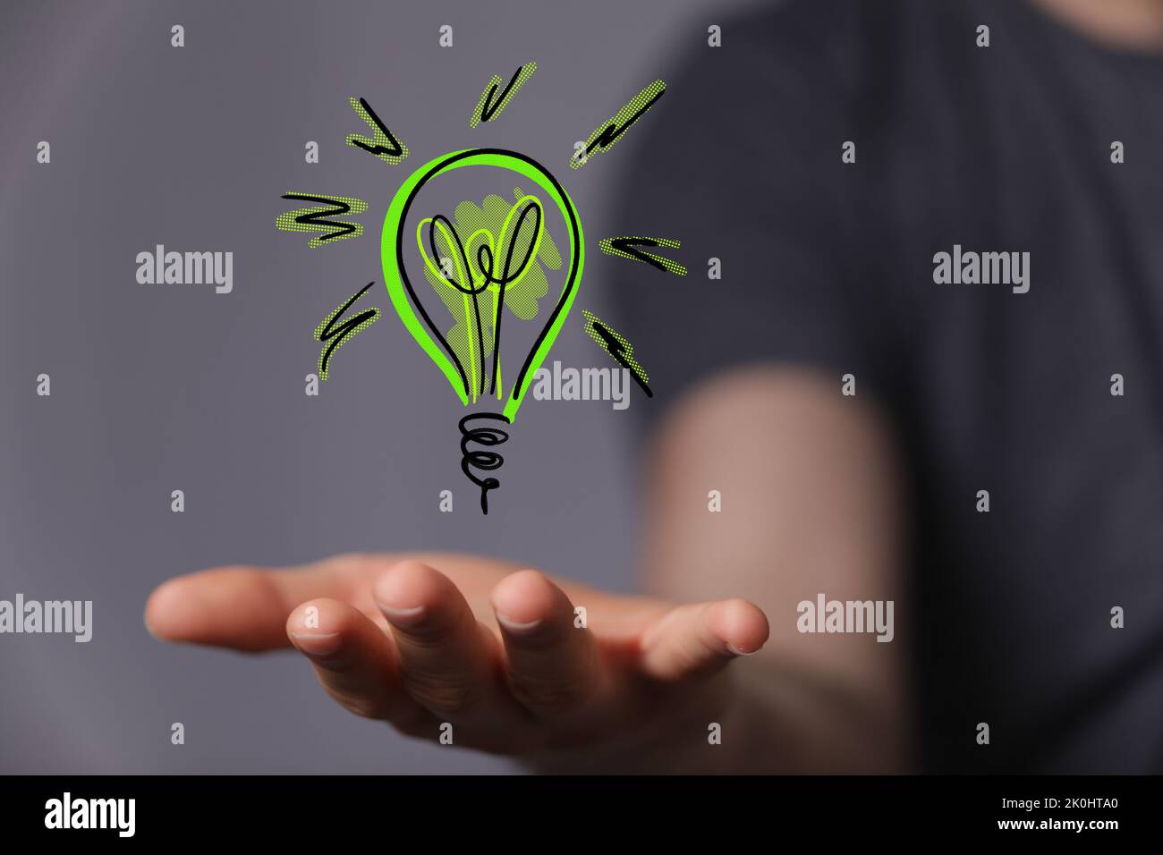 A man presenting illustrated light bulb over his hand Stock Photo - Alamy