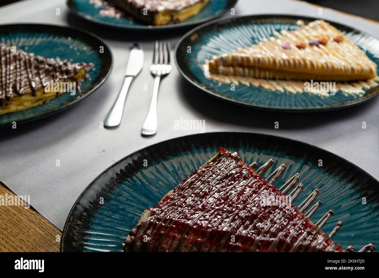 A shot of the different crepes with toppings on a plate Stock Photo - Alamy