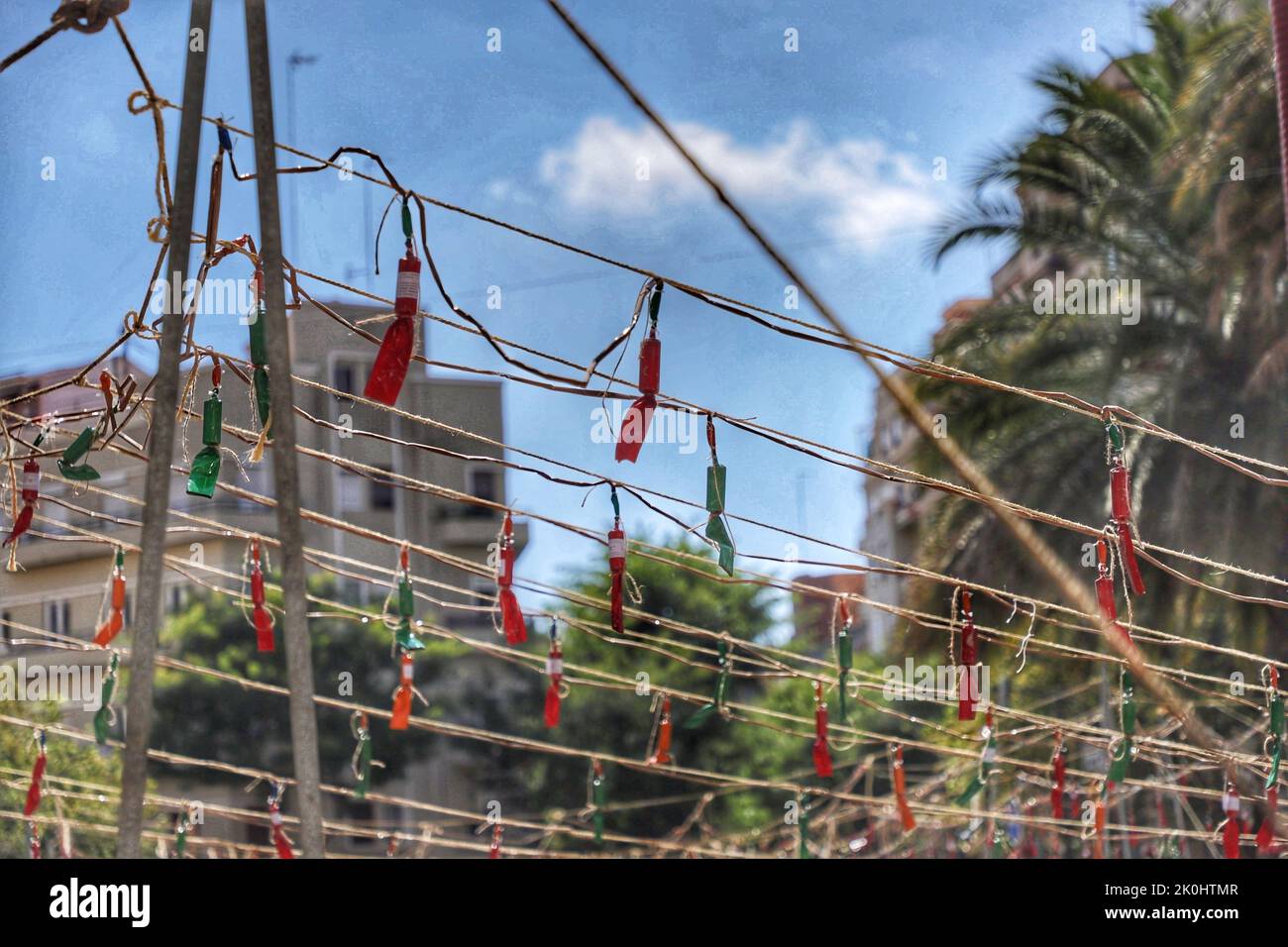 Set of firecrackers of different colors tied on ropes during an event ...