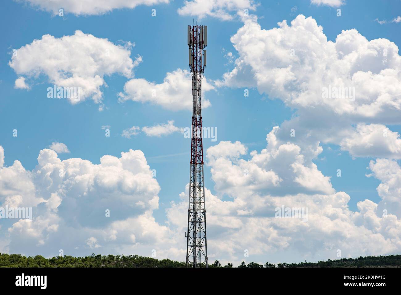 A high base station on a cloudy sky background Stock Photo - Alamy