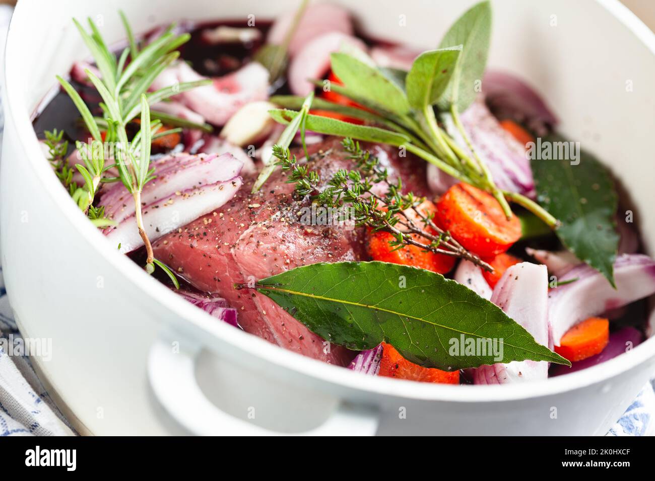 Beef rump cap with ingredients for brasato in a cooking pan Stock Photo ...