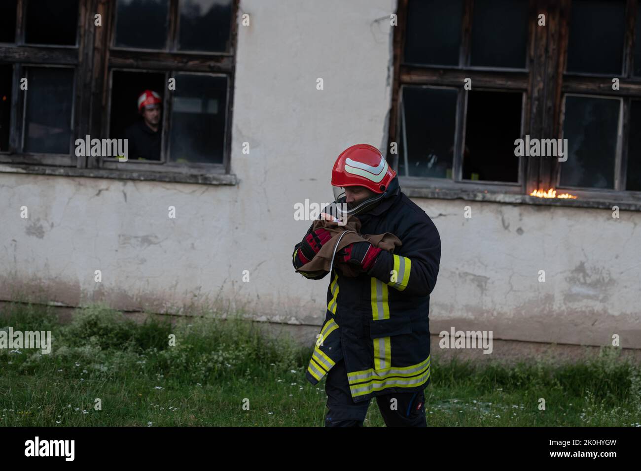 Firefighter hero carrying baby girl out from burning building area from ...