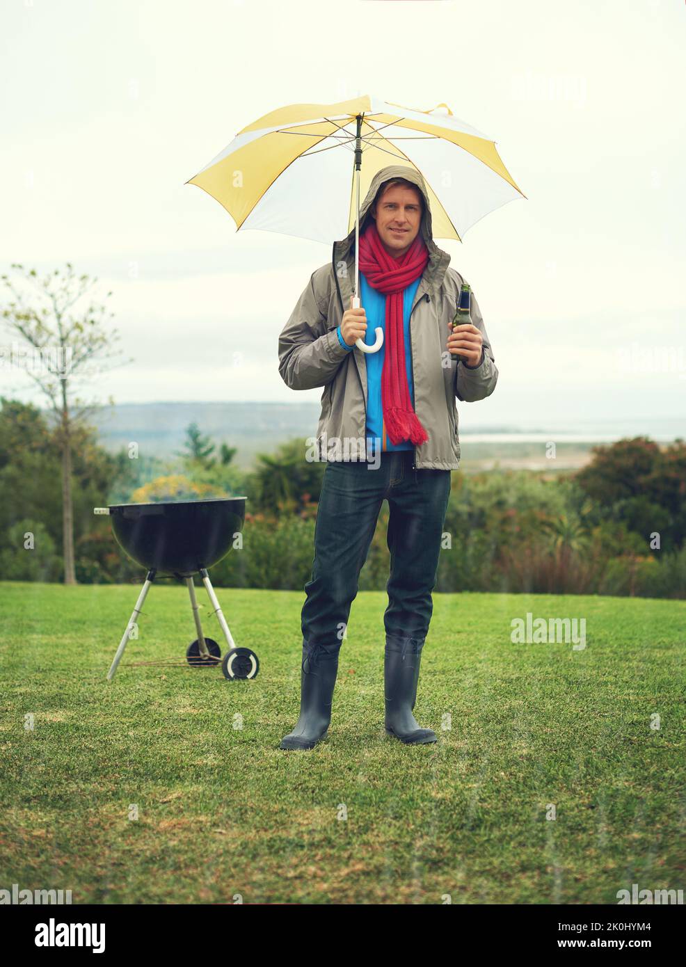 Man holding umbrella in rain hi-res stock photography and images - Alamy