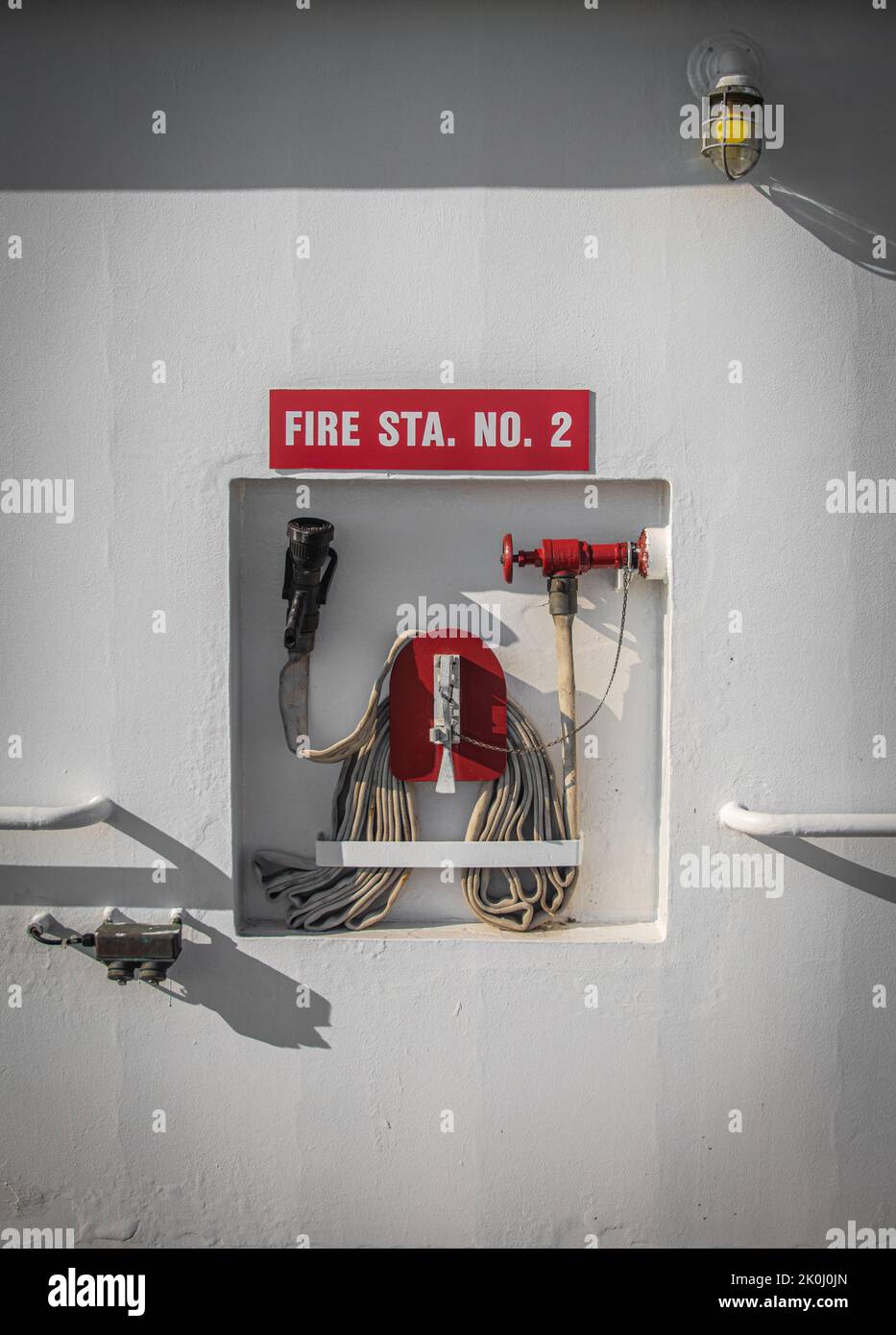 a fire hose connection on a ship ready to be used Stock Photo - Alamy