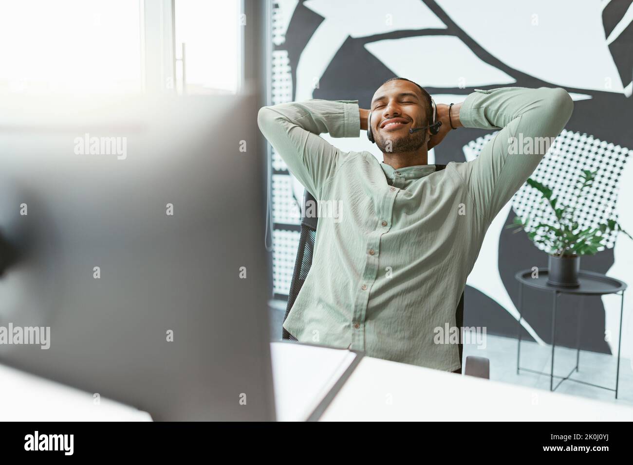 Happy african businessman have a rest after working on computer in ...
