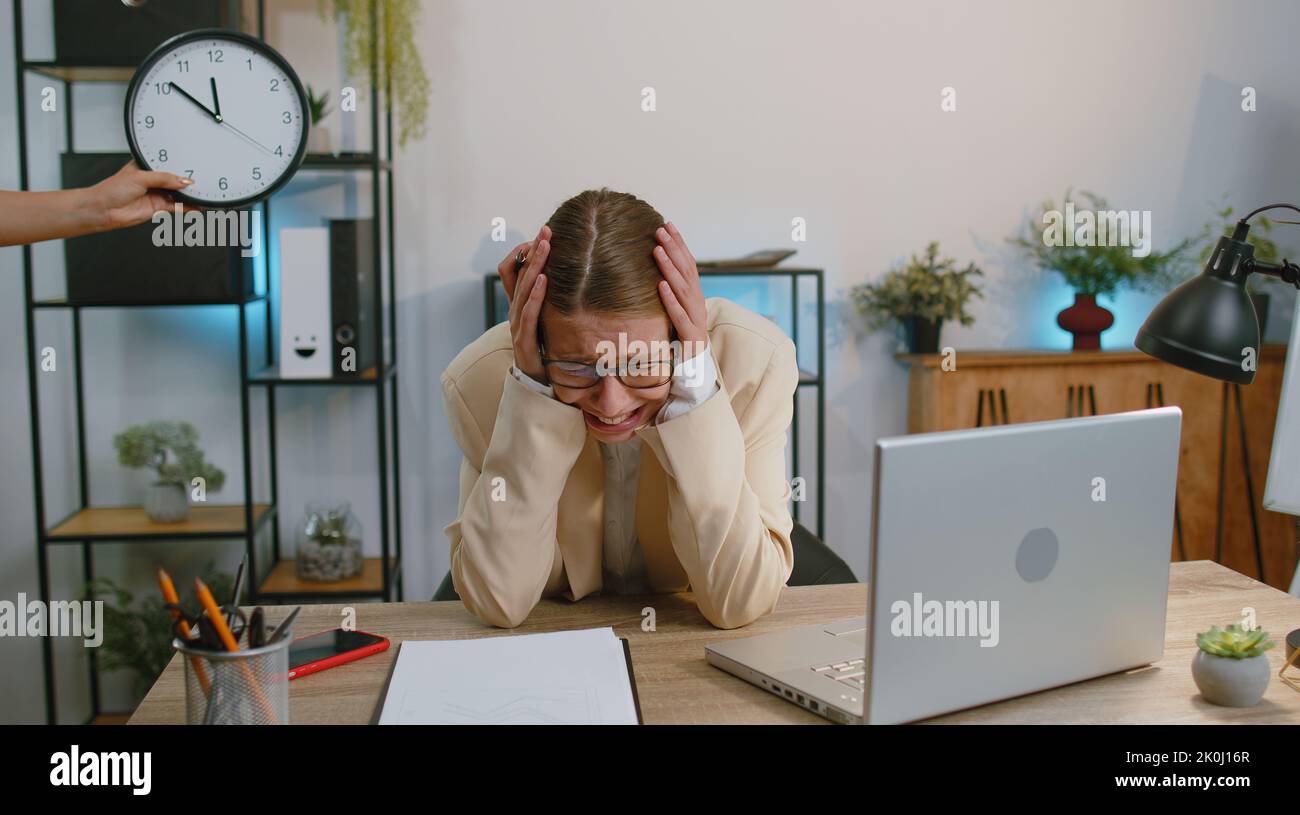 Woman checking clock office hi-res stock photography and images - Alamy