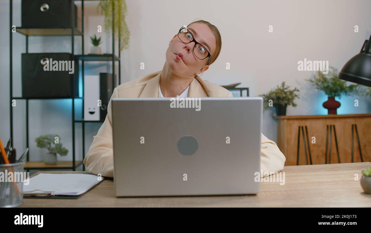 Business woman hiding behind laptop computer, making funny face ...