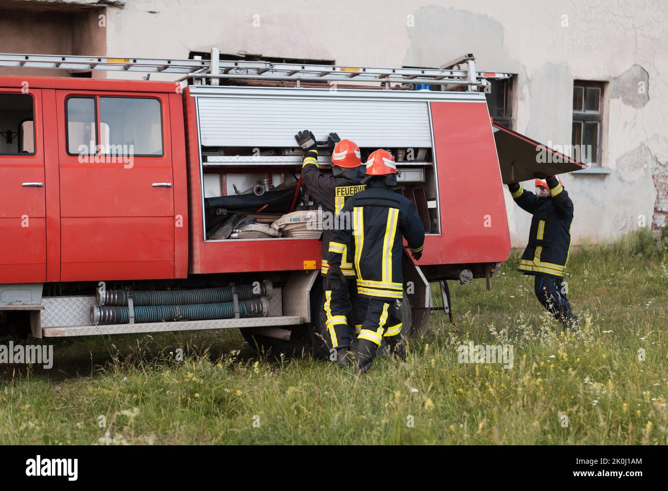 Group of fire fighters standing confident after a well done rescue ...