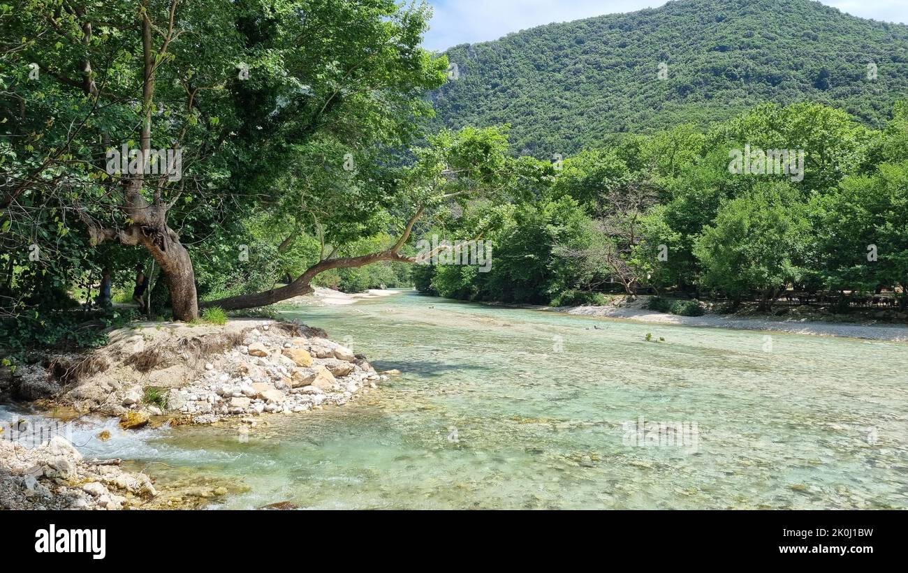 The Acheron river on the background of green hill in Greece Stock Photo ...