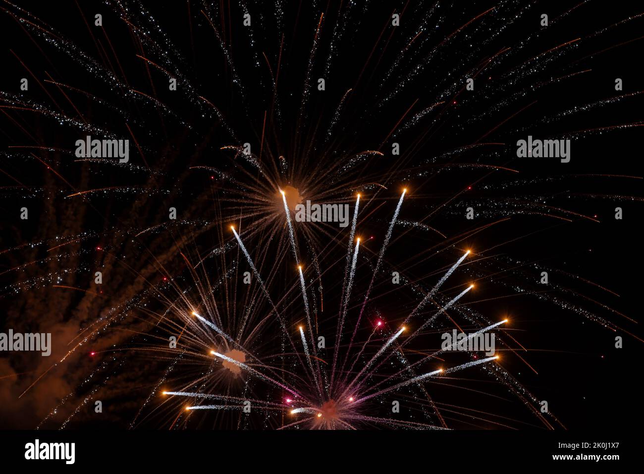 A sparkly burst of orange fireworks in the night sky Stock Photo - Alamy