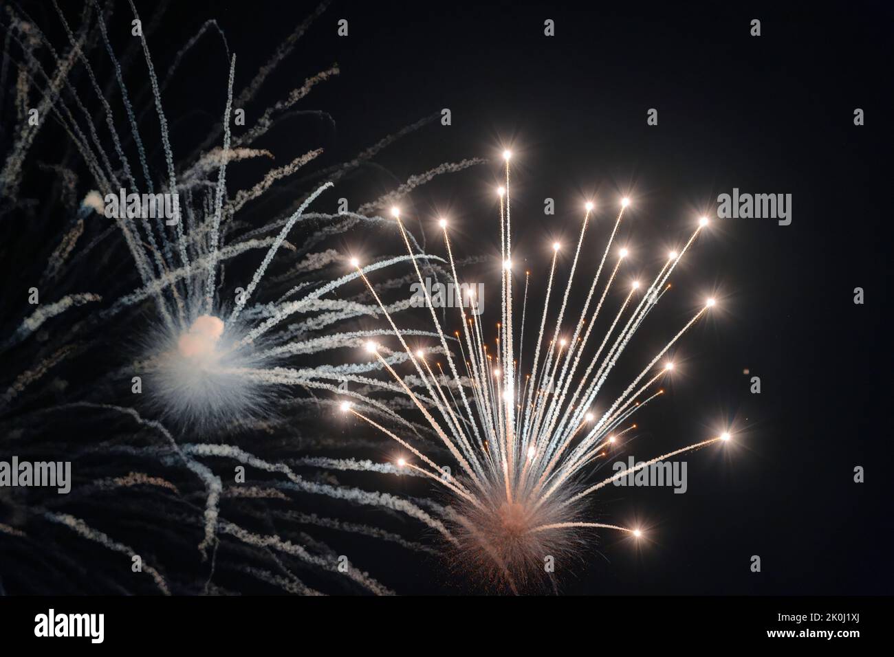 A sparkly burst of fireworks in the night sky Stock Photo - Alamy