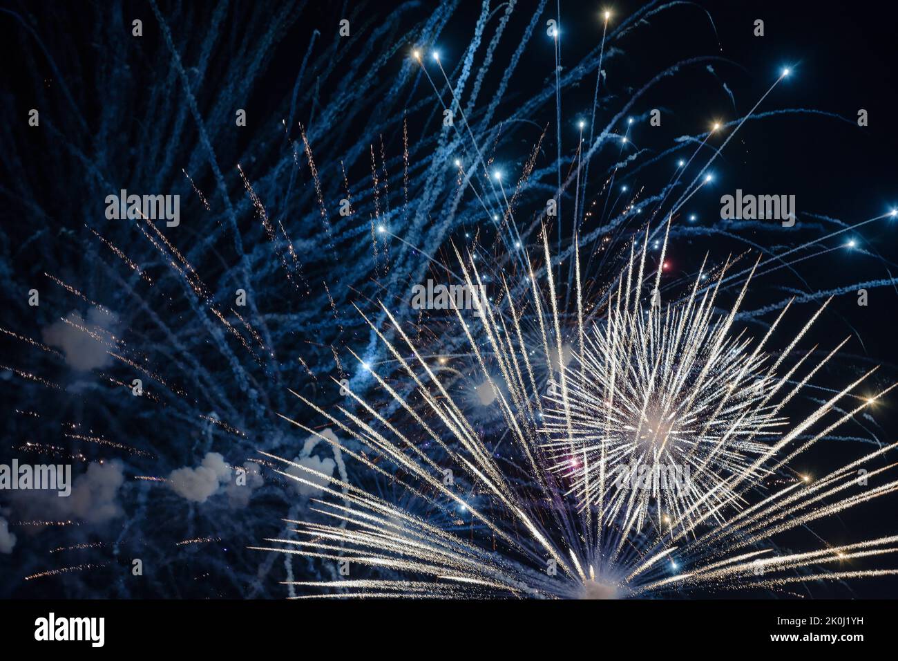 A night sky full of sparkly blue fireworks Stock Photo - Alamy