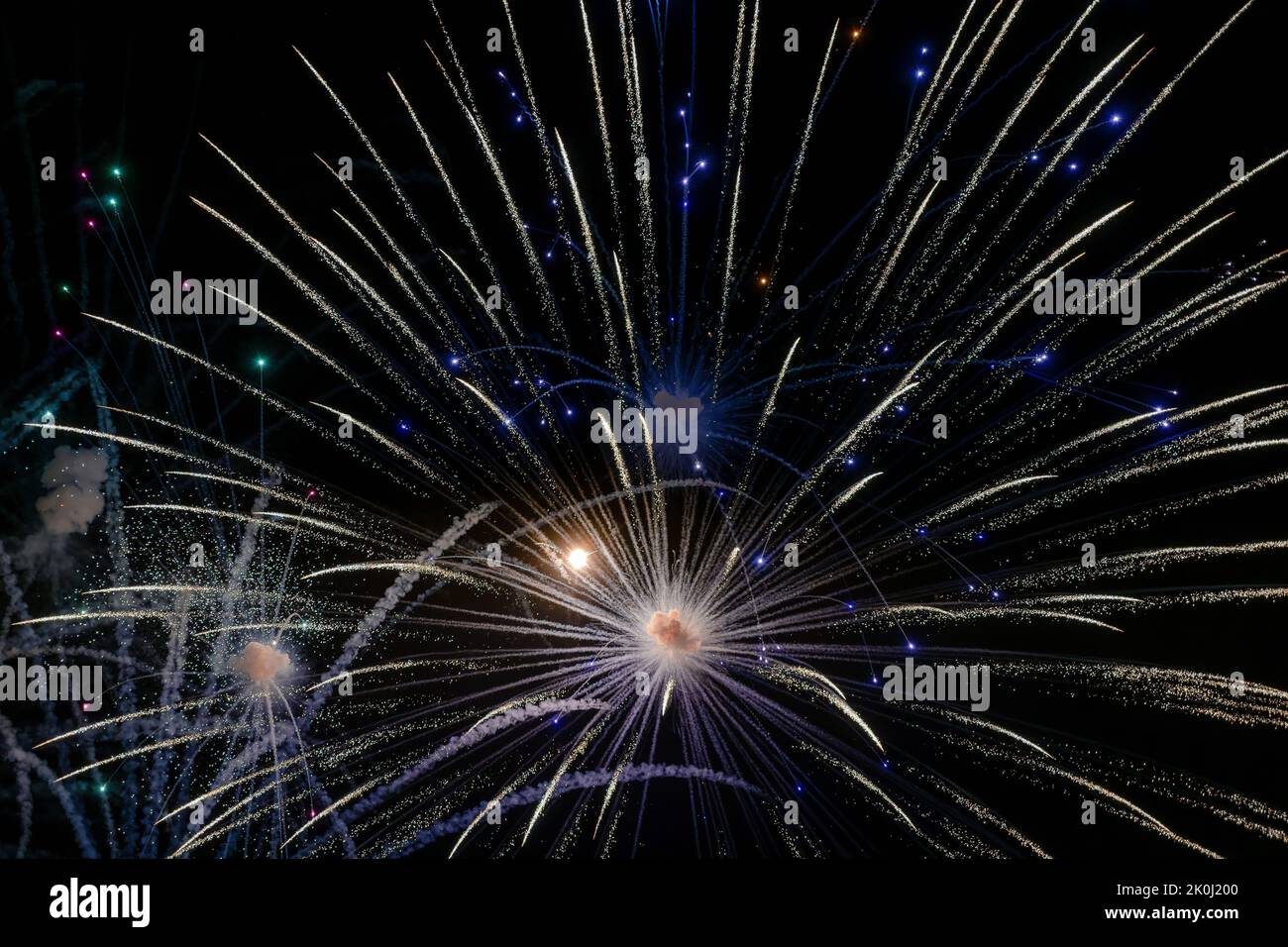 The falling of firework sparks after a big burst Stock Photo - Alamy