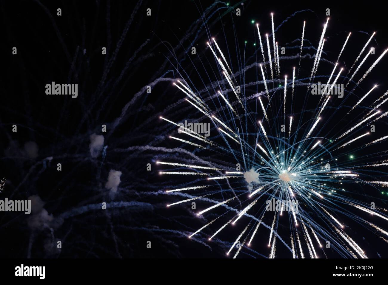 A sparkly burst of fireworks in the night sky Stock Photo - Alamy