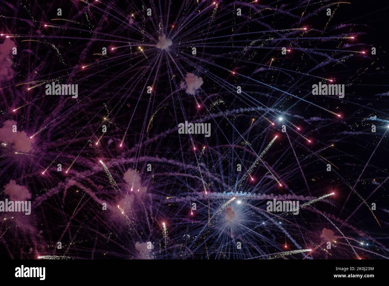 The night sky full of red firework sparks and smoke Stock Photo - Alamy