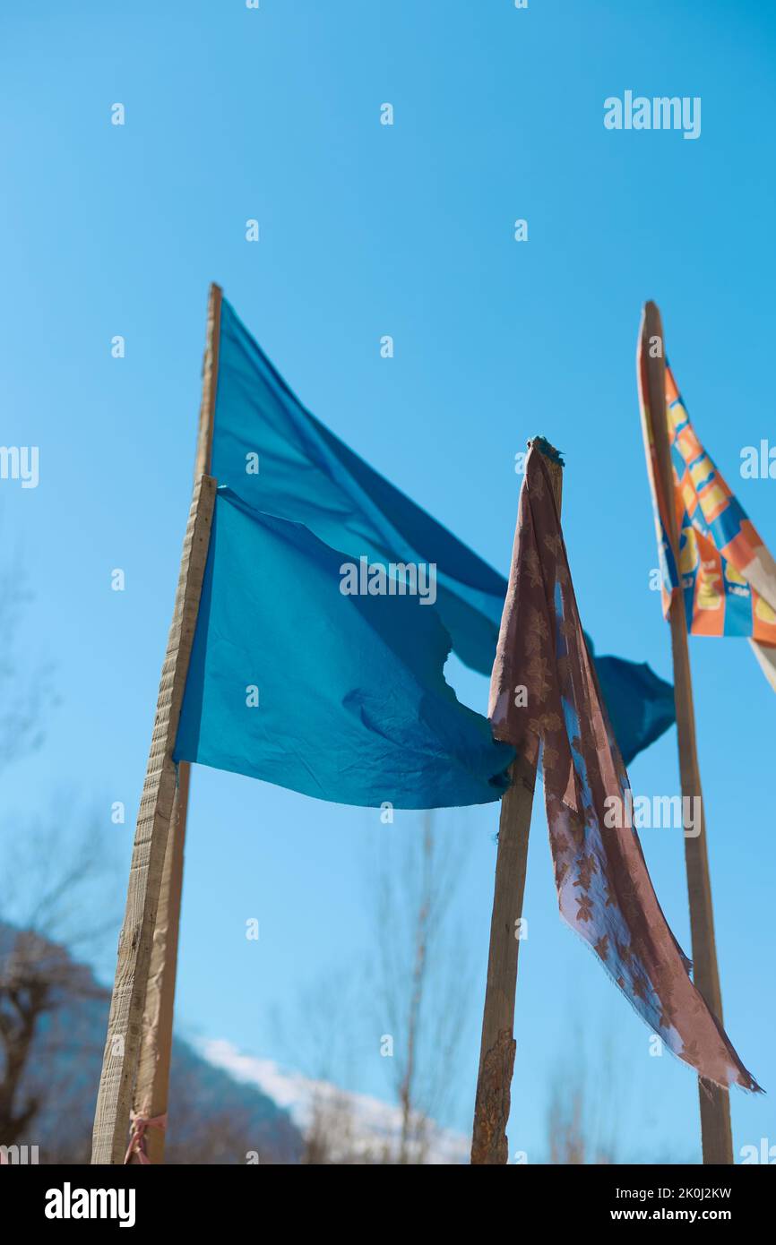 A vertical shot of old ripped flags on poles in Swat, Pakistan Stock ...