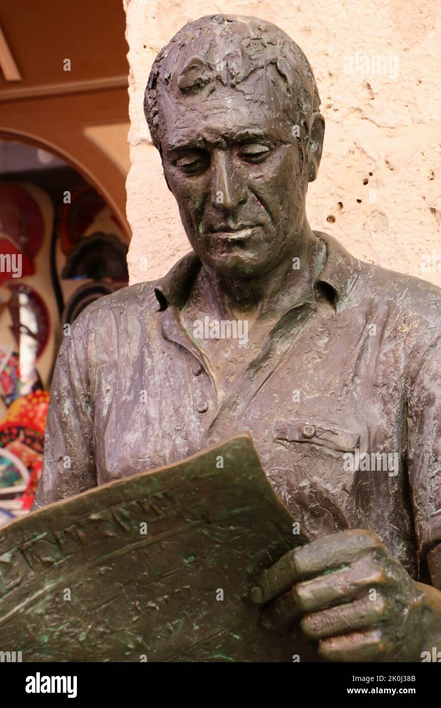 The reader bronze life size statue of a man reading a newspaper El ...