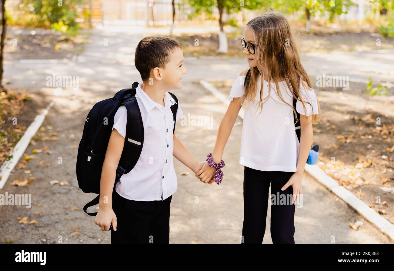 Two funny happy students kids on 1 September day. Education and back to ...