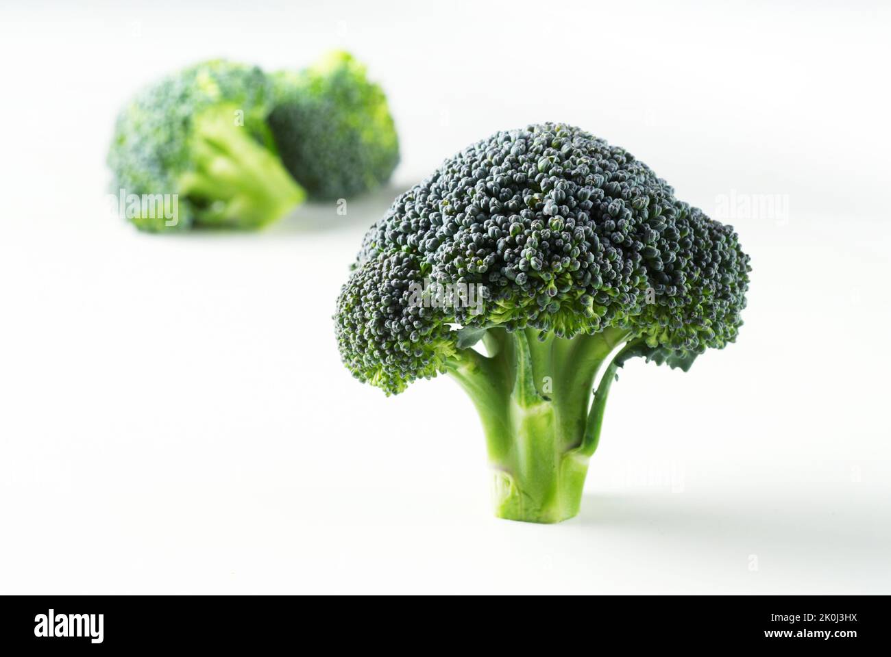 Fresh raw broccoli stems on white background Stock Photo - Alamy