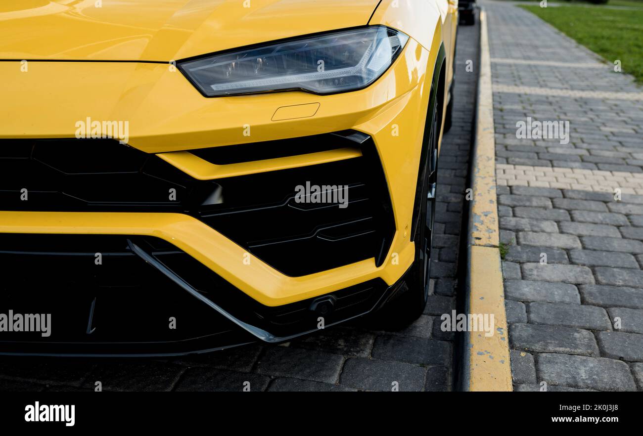 view of yellow brand new modern luxury sport car parked outdoors ...