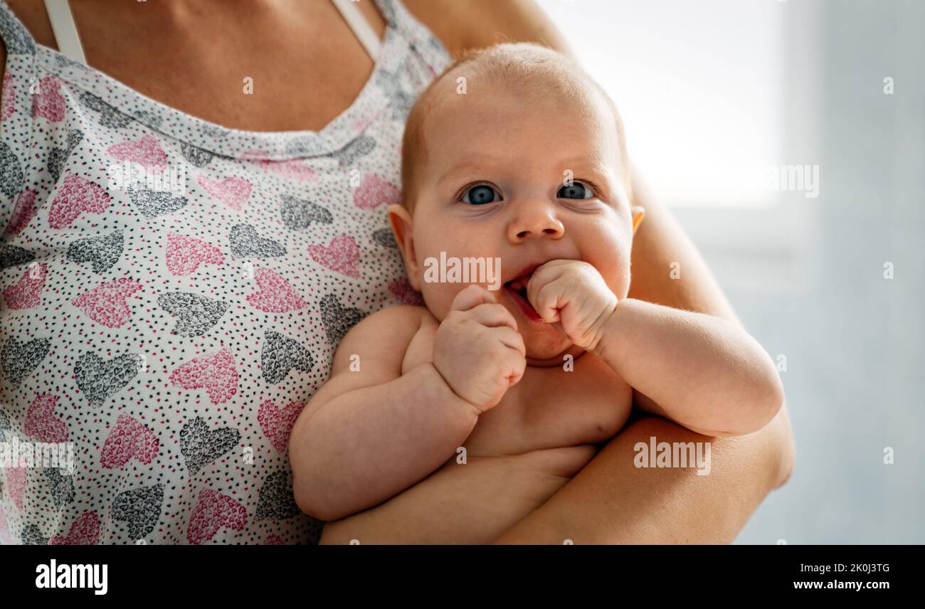 Young tender happy mother hugging her newborn baby smiling Stock Photo ...