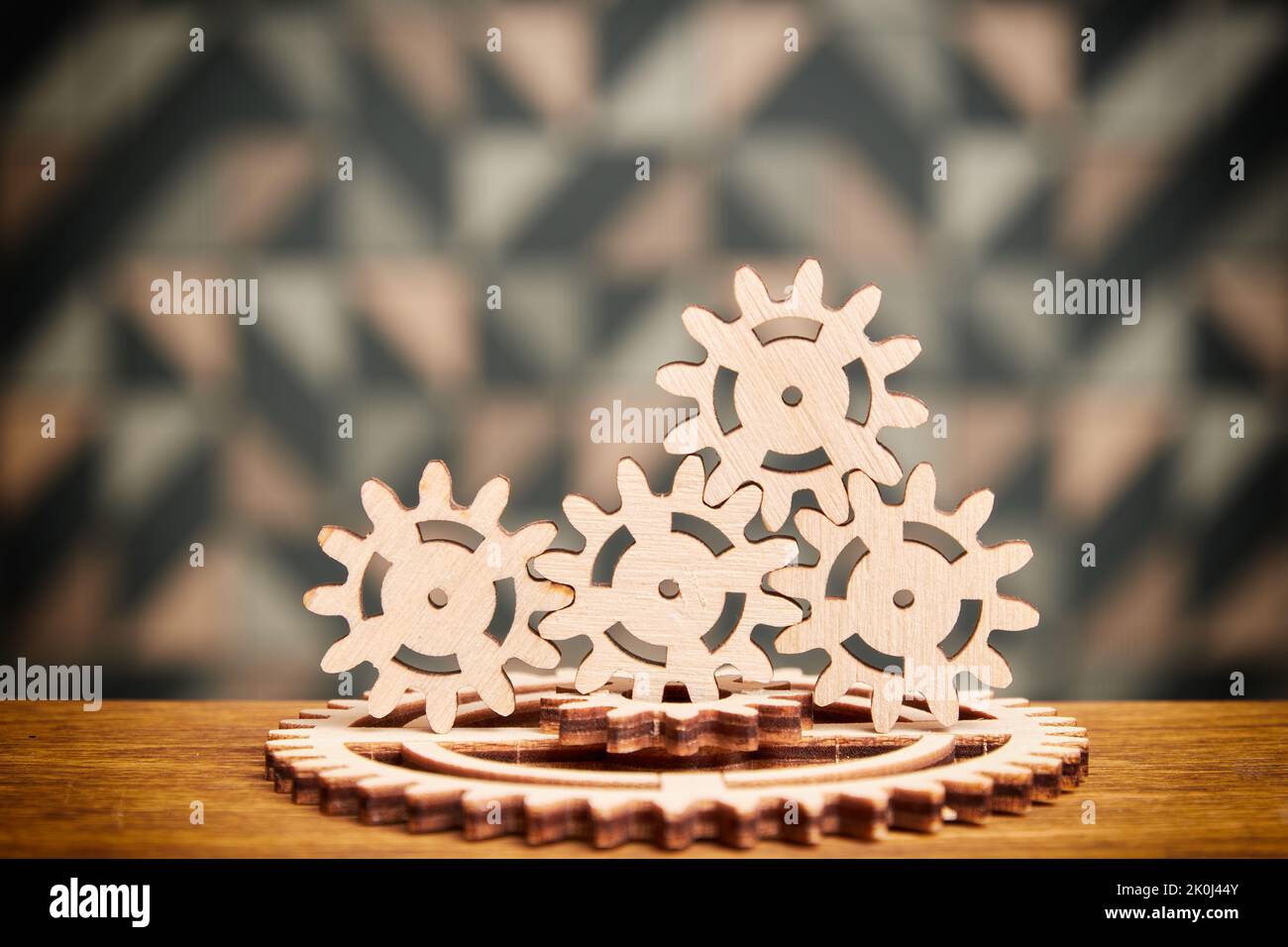 Wooden mechanical puzzle and gears on the table. Toy and game parts and ...