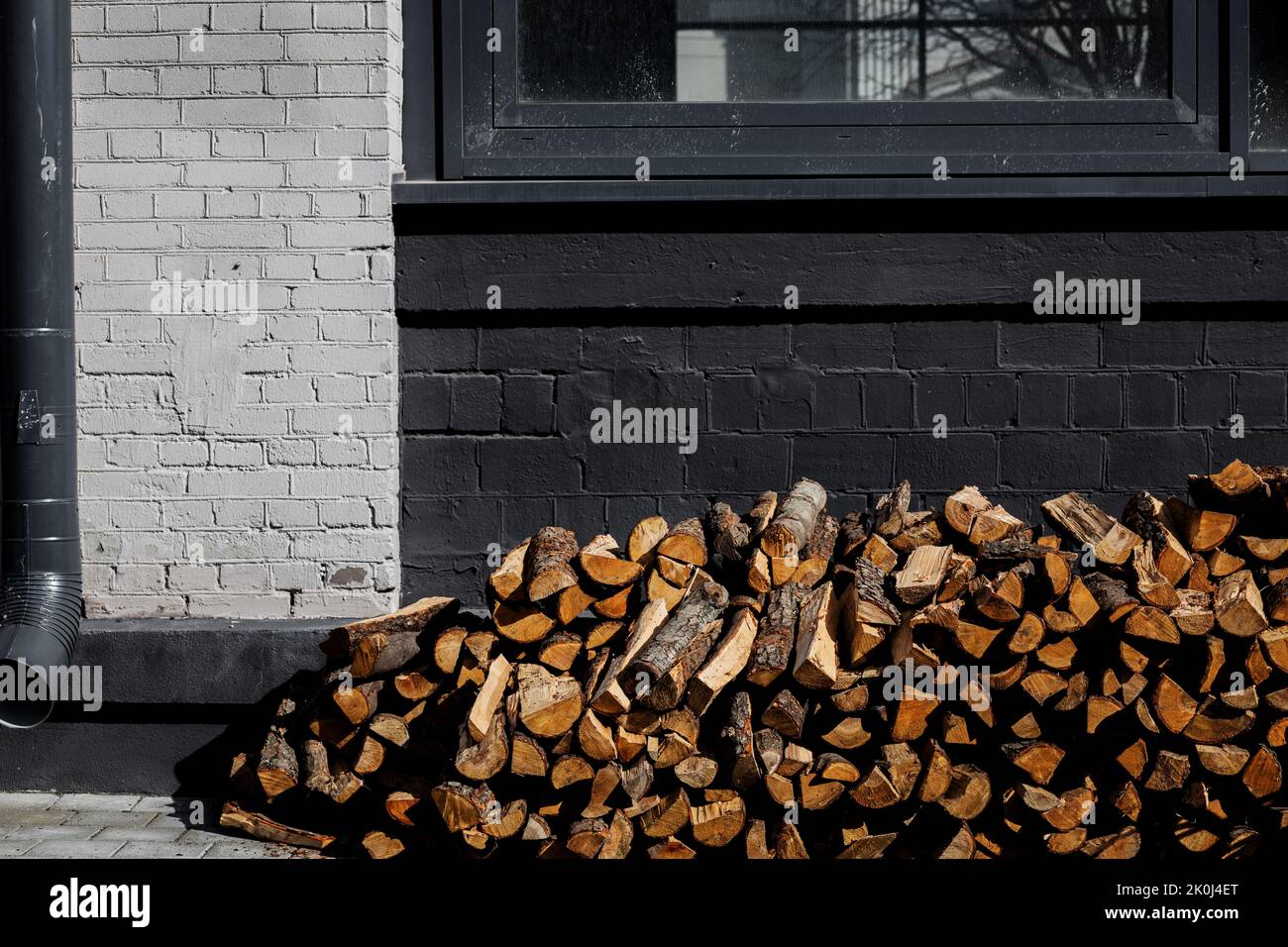 wood logs ready for heating in winter stacked in storage place in a ...