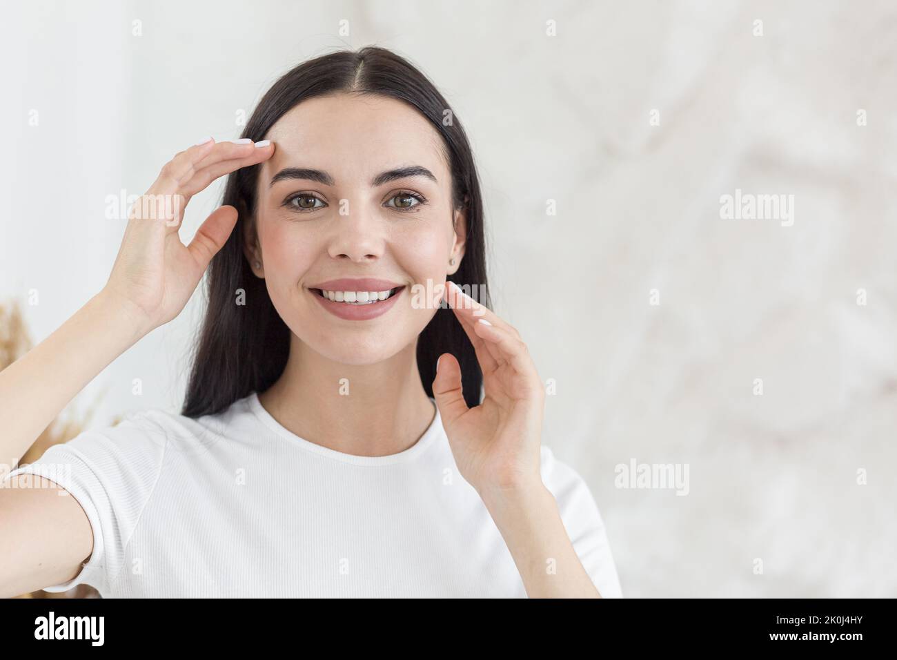 Cosmetology. Close-up portrait of young beautiful brunette woman with ...