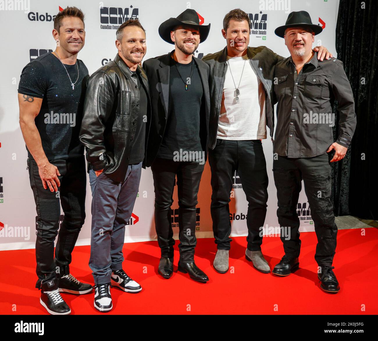 Brett Kissel, centre, and 98 Degrees pose on the red carpet at the ...
