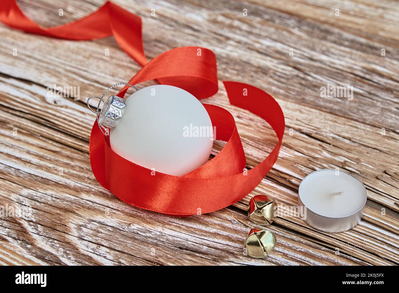 White christmas ball with red festive ribbon on wooden background Stock ...
